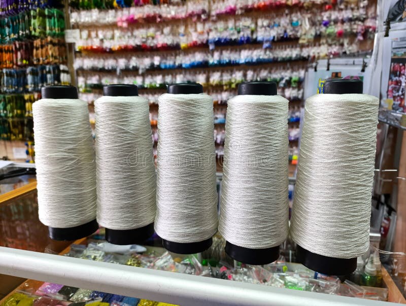 A Row of Spools of Thread on a Shelf in a Store Stock Photo - Image of ...