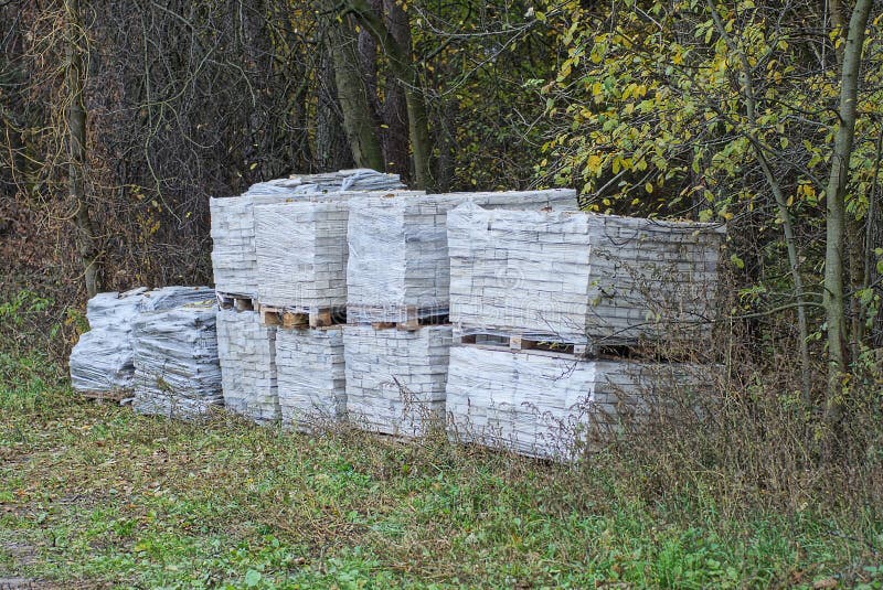 Row on Square Boxes in Plastic Packaging with Paving Bricks Stock Image ...