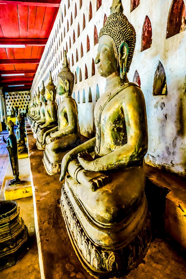 A Row of Statues of Buddha are Sitting on a Platform Stock Photo ...