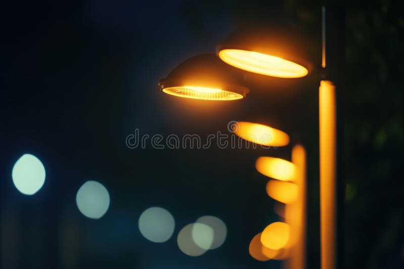 Row of Streetlights Lit Up at Night, Urban Scene Stock Photo - Image of ...