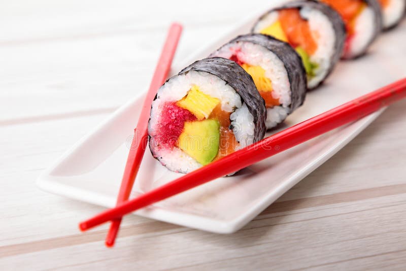 Row of Sushi with Chopsticks on Plate Stock Image - Image of sushi ...