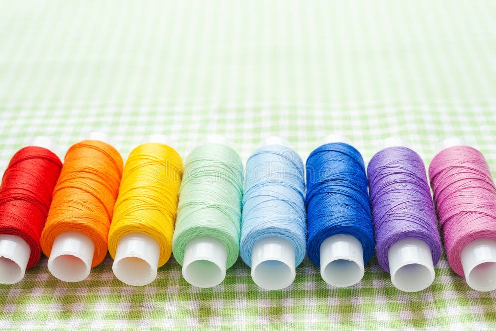 Row of Thread Spools in Rainbow Colors Stock Photo - Image of copyspace ...