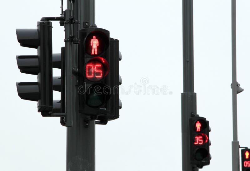 Three Red Traffic Lights Hang Over the Road Against the Blue Sky ...
