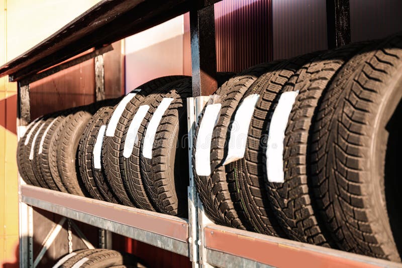 Row of Tires on Rack in Store Stock Photo - Image of industry, texture ...