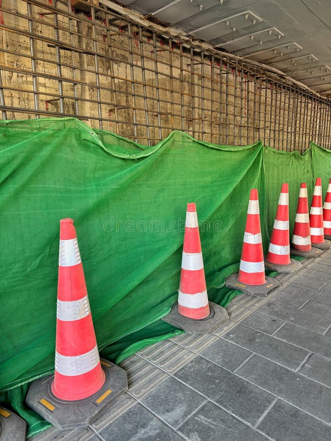 Row Traffic Cones Front Concrete Wall Covered Green Mesh Stock Photos ...