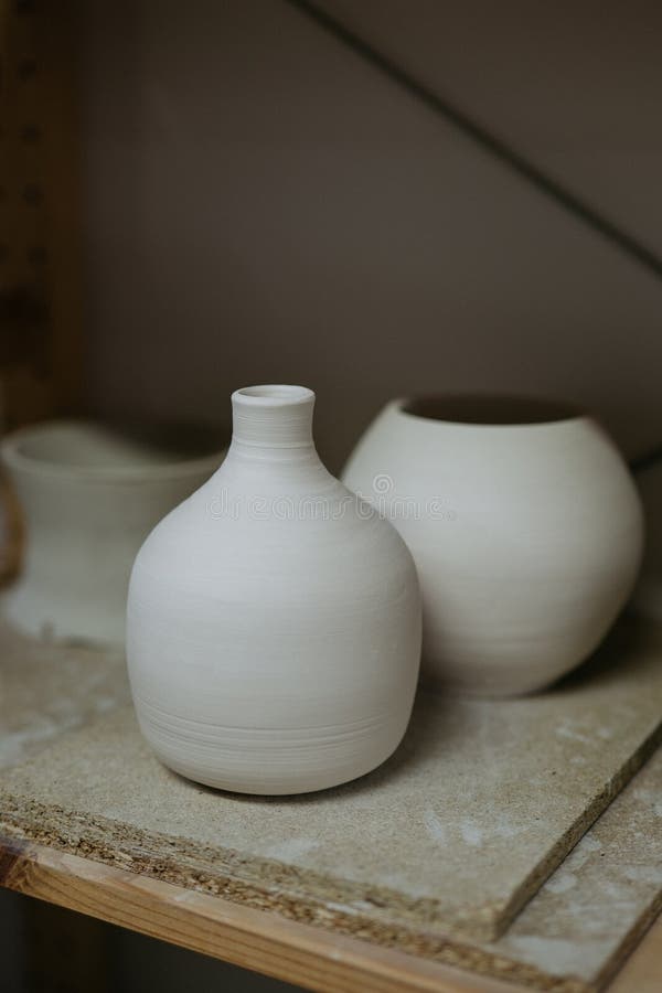 Unfinished White Ceramic Vases on a Shelf Reflecting the Process of ...