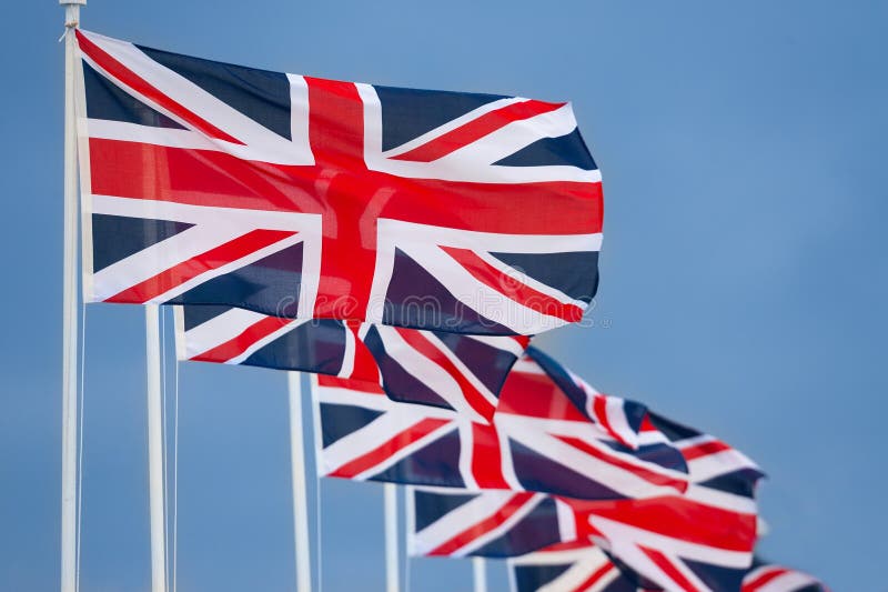Row of Union Jack British Flags on Flagpoles Stock Photo - Image of ...