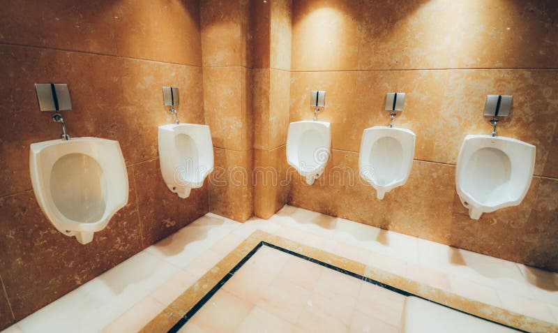 A Row of Urinals in Tiled Wall in a Public Restroom Stock Image - Image ...