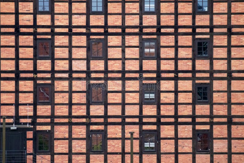 A Row of Vertical and Horizontal Windows in a Red Brick and Timber ...