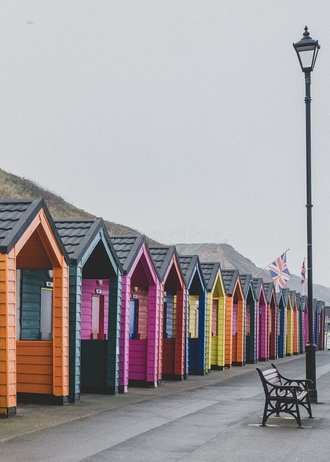Row of Vibrant Bathing Huts with Waving British Flags. Stock Image ...