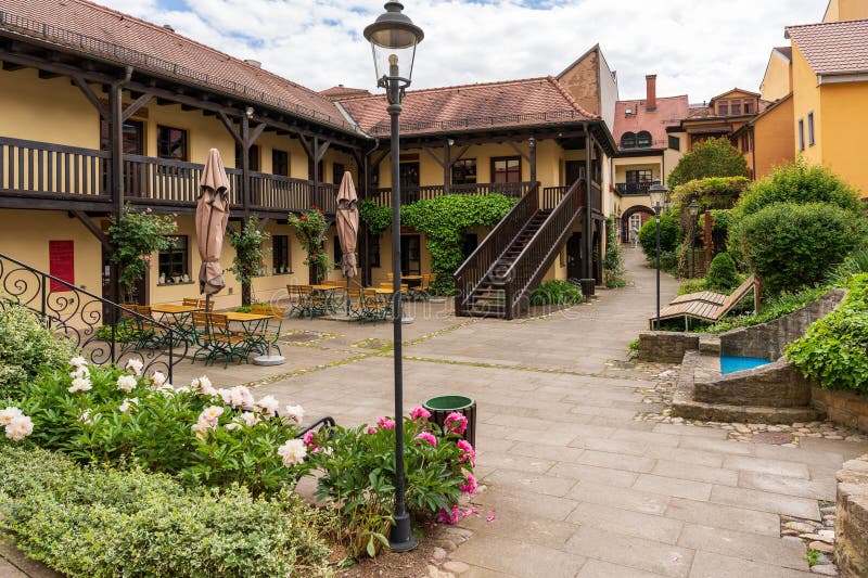 Row of Vintage Buildings with a Quaint Garden and Pathways in Front ...