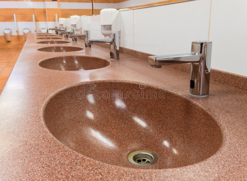 Row of Washbasins with Automatic Taps and Ceramic Sinks in a Public ...