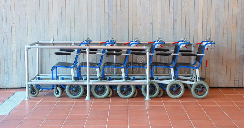 Row of Wheel Chairs, Chained Stock Photo - Image of support, wall ... Row of Wheel Chairs, Chained Stock Photo - Image of support, wall ...