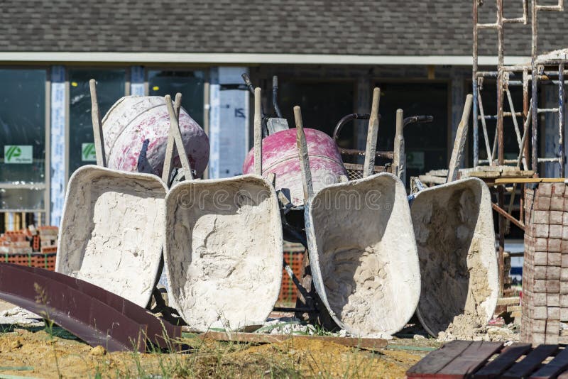 Row of Wheelbarrows stock image. Image of cart, building - 120590783