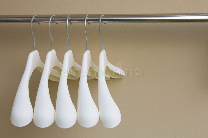 Row of white cloth hangers stock image. Image of shirt - 127608231