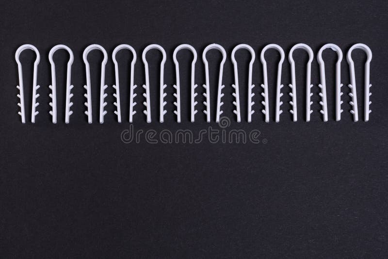 A Row of White Plastic Fasteners on a Black Background Stock Photo ...