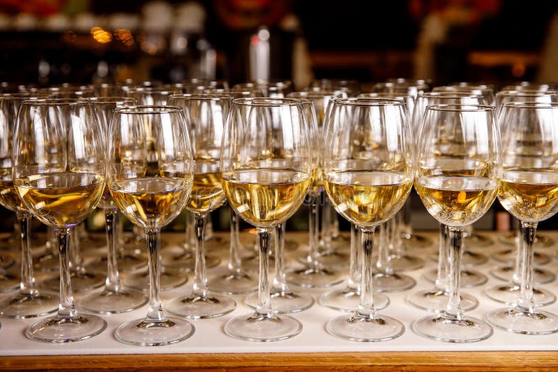 Row of White Wine in Glasses Stock Image - Image of bottle, glasses ...