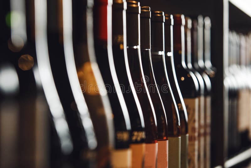 Row of Wine Bottles Lined Up on Modern Storage Shelf at Dusk Ambient ...