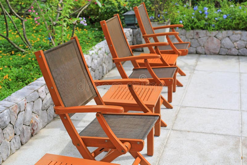 Row of Wooden Chairs Set beside a Pool Stock Photo - Image of ...