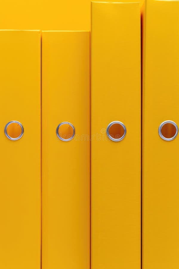 A Row of Yellow Binders with Holes, Perfect for Organizing and Storing ...