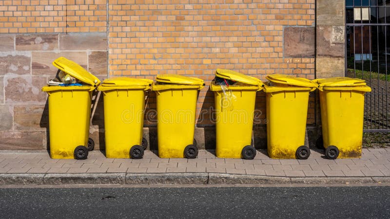 Row of Yellow Garbage Bins on the Sidewalk Stock Image - Image of ...