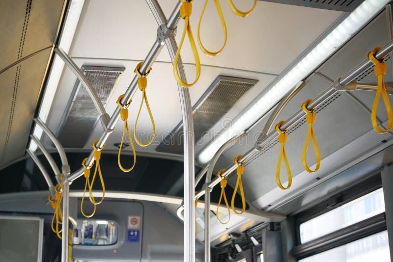 A Row of Yellow Handle on a Bus Stock Image - Image of morning, empty ...