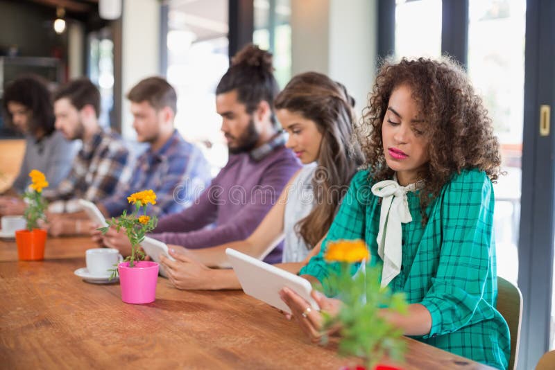 Row of Young People Using Digital Tablets Stock Image - Image of ...