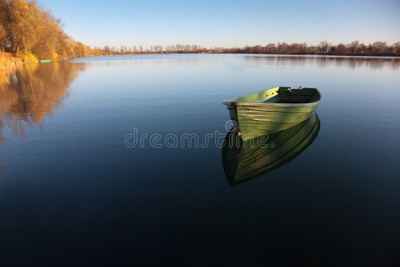 Rowboat At Lake Shore At Dusk Stock Photo - Image of outdoor, evening ...