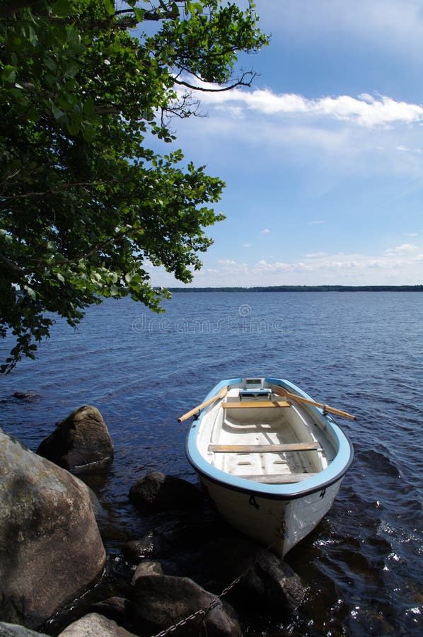 Rowboat in a Swedish lake stock photo. Image of rocks - 15305628