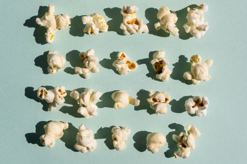 Rowes of Salt Popcorn on the Light Blue Background. Stock Image - Image ...