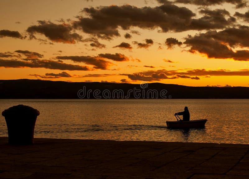Rowing alone in sunset stock image. Image of alone, catch - 29254419