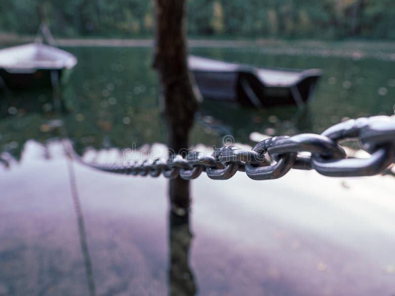 Rowing Boat is Attached To a Steel Chain, Which Floats on a Lake Stock ...