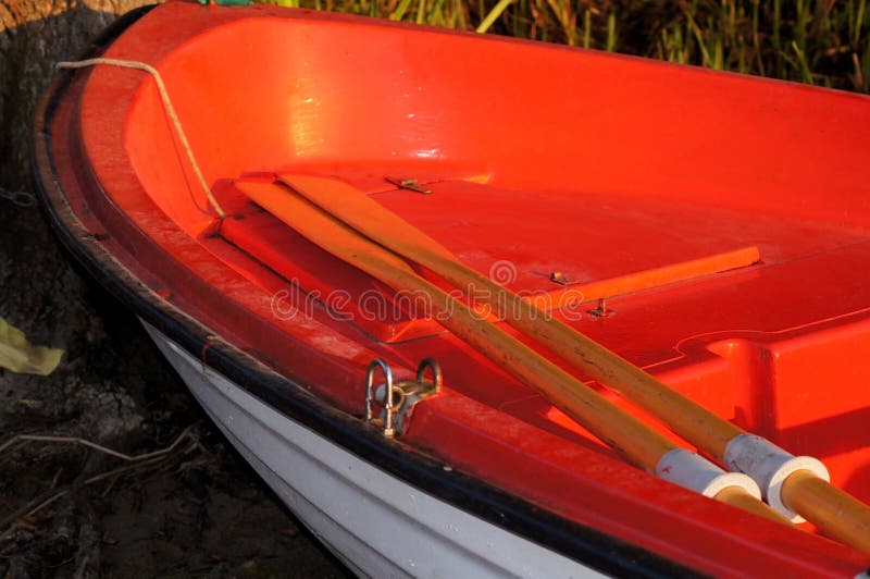 Rowing Boat with Paddle and Anchor on the Lake Shore Stock Photo ...