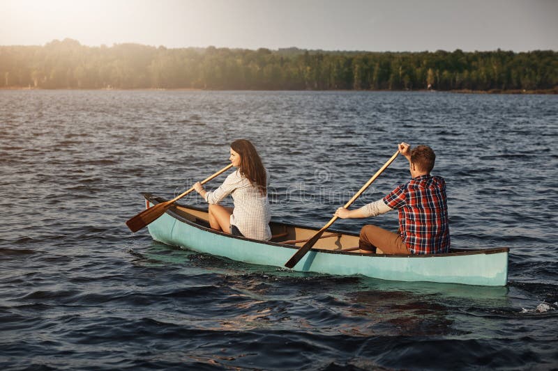 Rowing Could Also Make for Great Exercise. a Young Couple Rowing a Boat ...