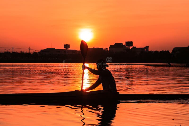 Rowing kayak in sunset stock image. Image of leisure - 105221049
