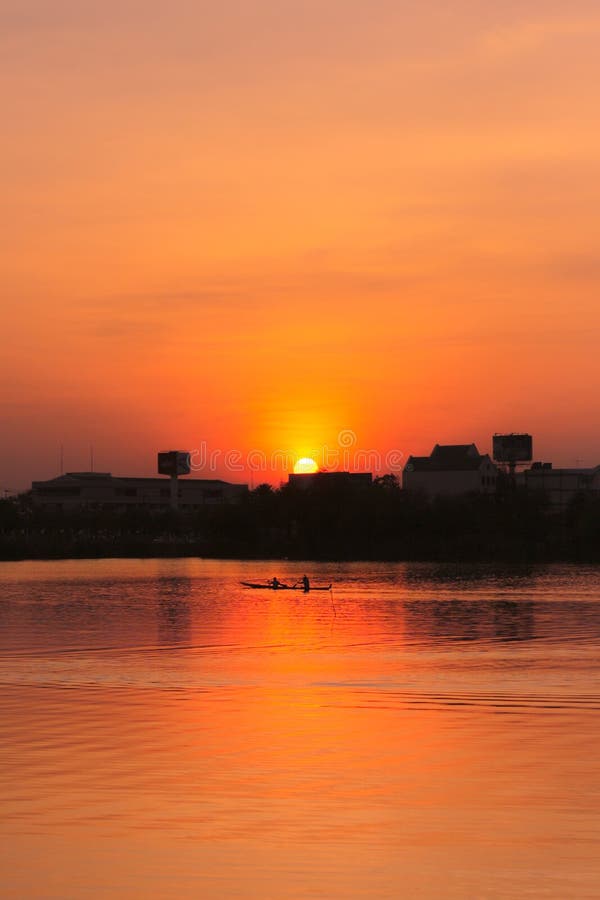 Rowing kayak in sunset stock photo. Image of people - 105221432