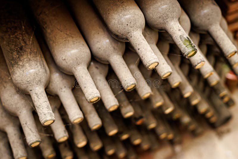 Rows of Aged Wine Bottles in a Rustic Cellar Stock Image - Image of ...