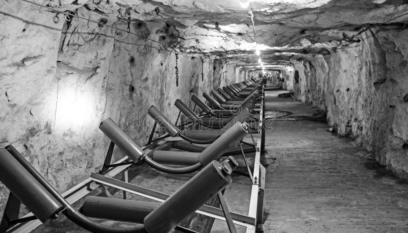 Rows of Black Pipes in a Tunnel with Rock Walls Editorial Image - Image ...