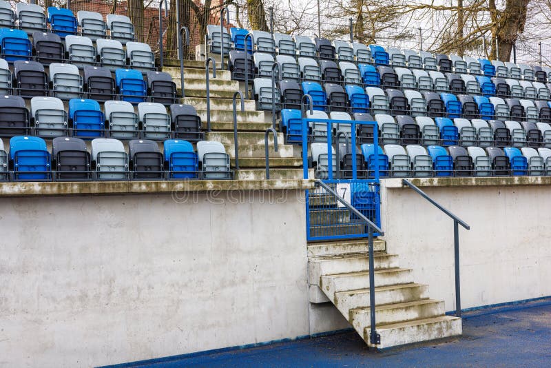 Rows of Blue and Grey Numbered Seats in a Stadium Near an Aisle with ...