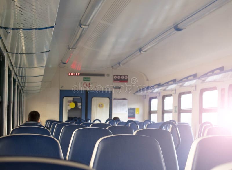 Rows of Blue Soft Seats in a Passenger Train Car. Bright Sun Shines ...