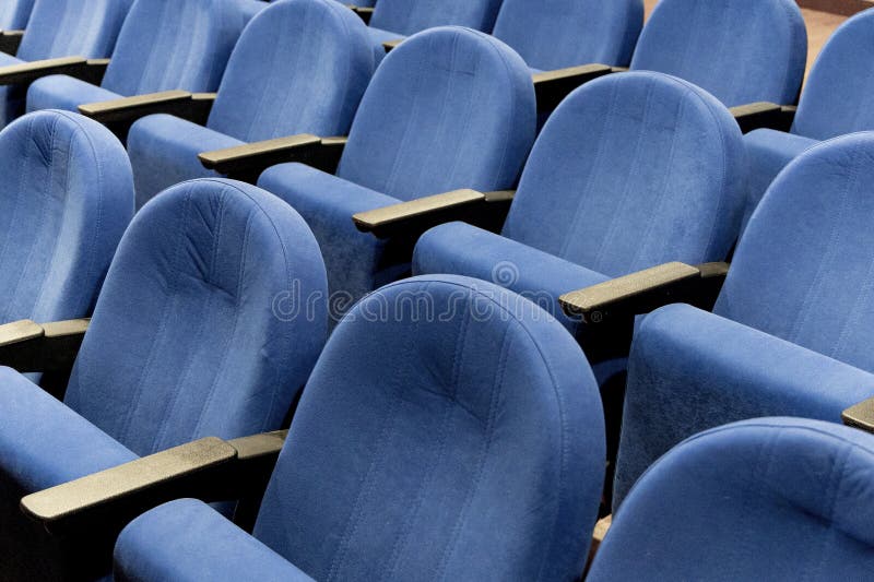Rows of blue theater seats stock image. Image of audience - 320636495