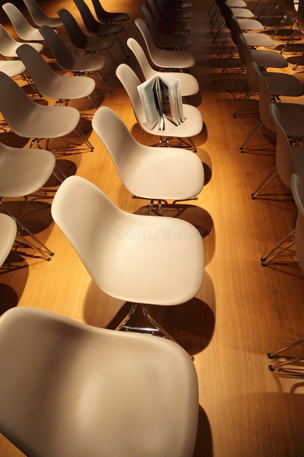 Rows of Chairs; Brochure Standing on Chair Stock Photo - Image of ...