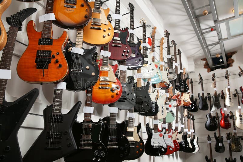 Rows of Different Guitars in Music Store Stock Photo - Image of rock ...