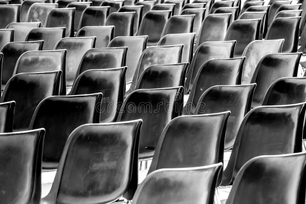 Rows of empty black chairs stock image. Image of pattern - 175879155