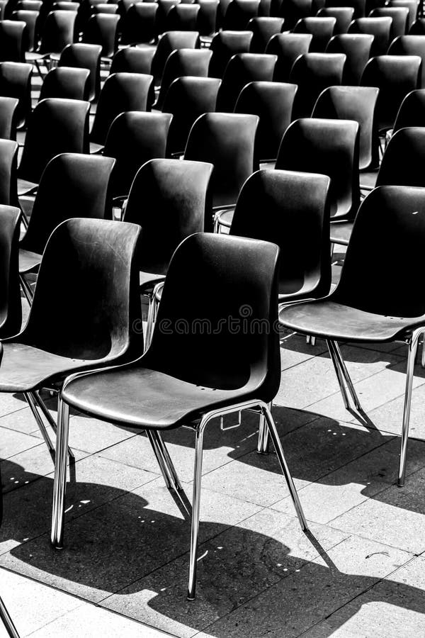 Rows of empty black chairs stock photo. Image of conference - 175879160
