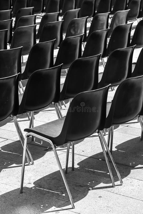 Rows of empty black chairs stock image. Image of chair - 175879173