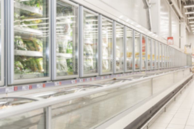 Rows of Frozen Food Display Cases in a Large Supermarket. Blurred Stock ...