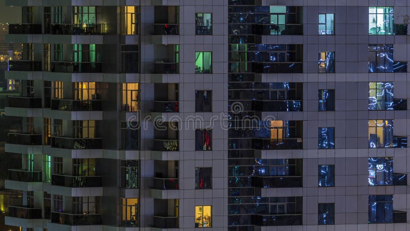 Rows of Glowing Windows with People in Apartment Building at Night ...