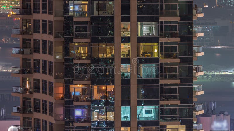 Rows of Glowing Windows with People in Apartment Building at Night ...