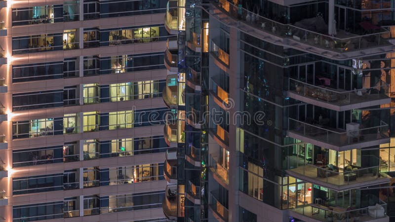 Rows of Glowing Windows with People in Apartment Building at Night ...
